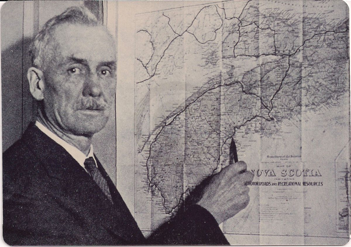 Frederick Blair pointing to Oak Island on map - Oak Island, Nova Scotia